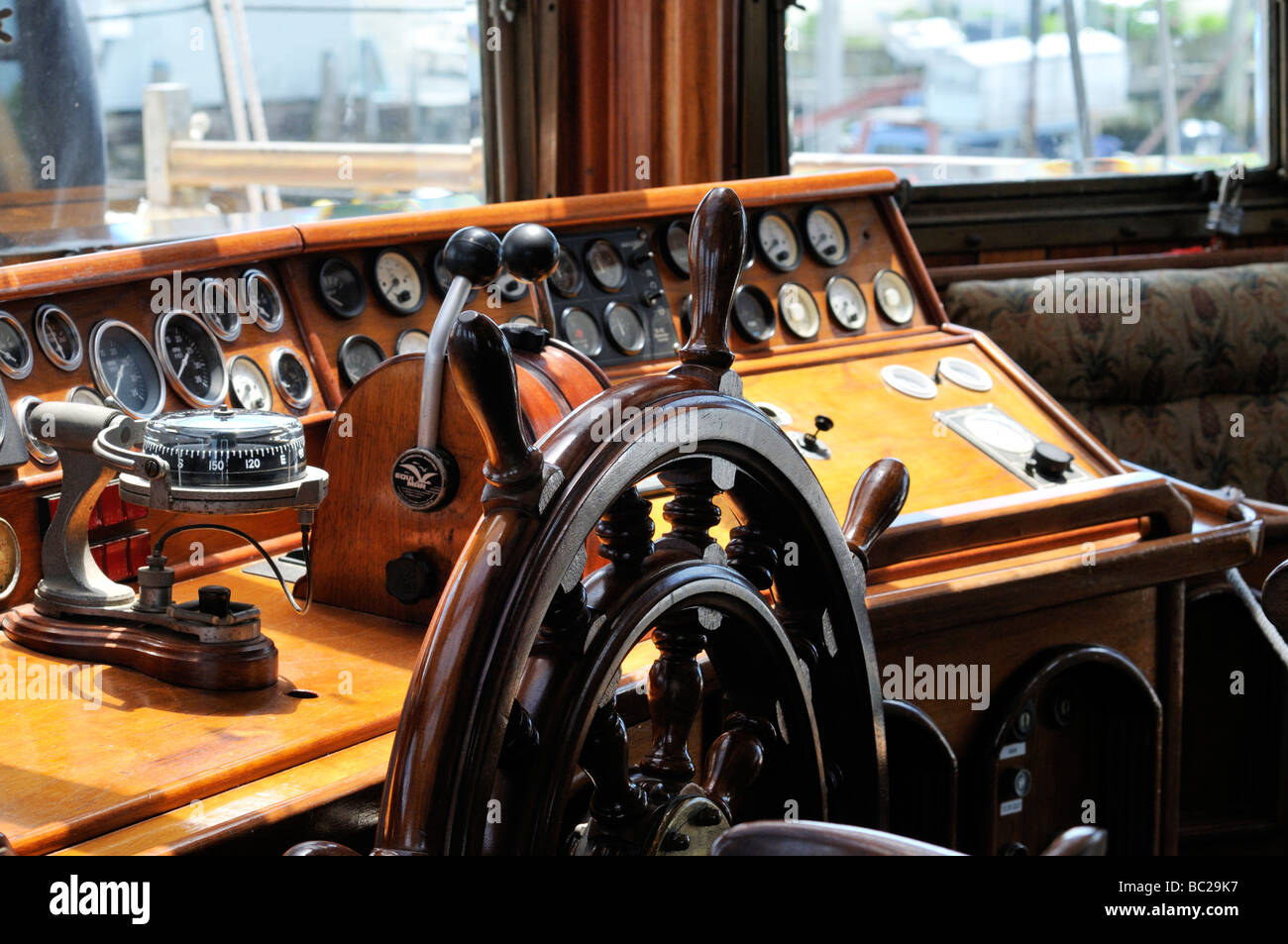 Ships wheel in pilot house of the tall ship Peacemaker with compass ...