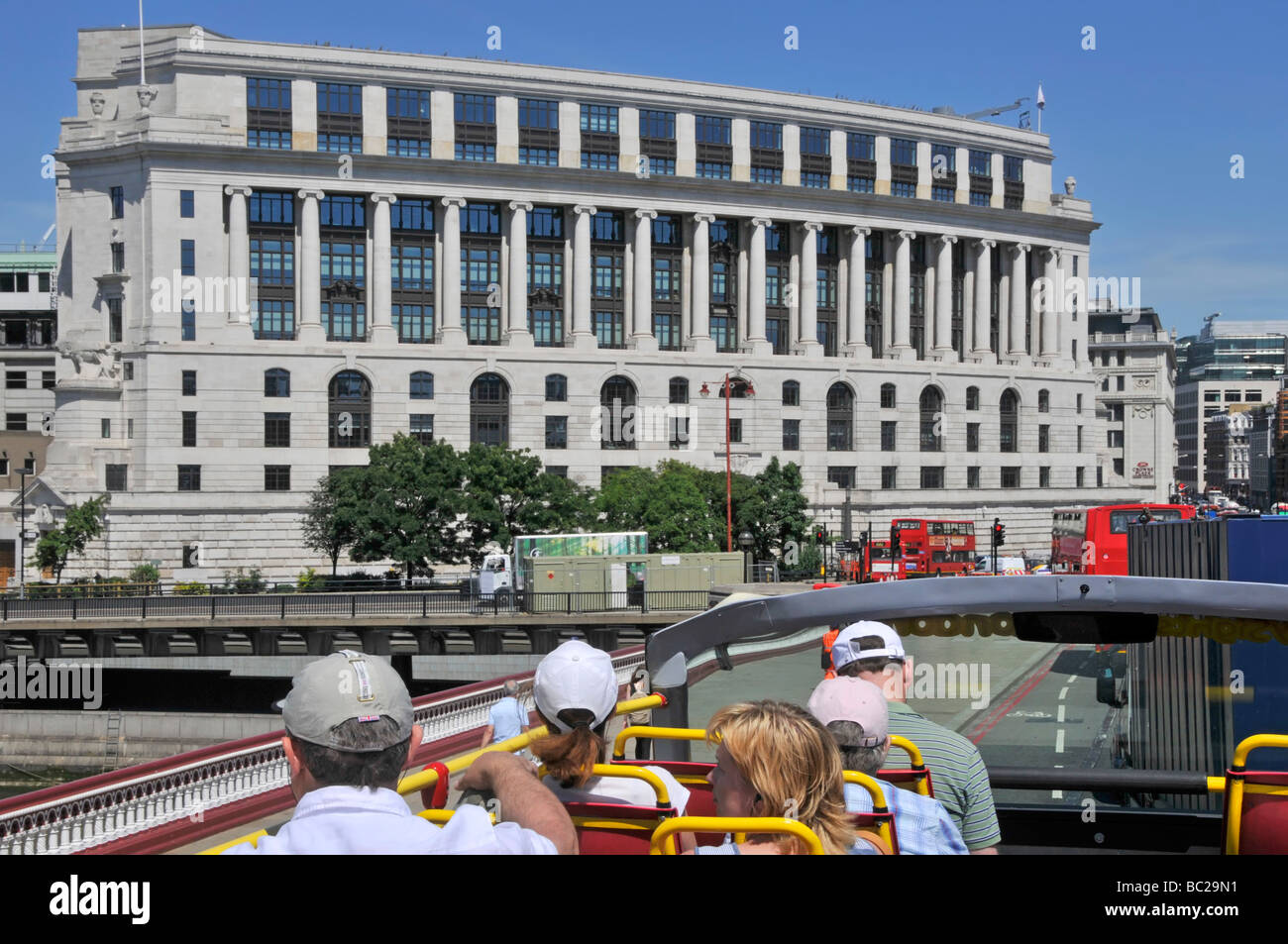 London open top tour bus tourist passengers and view of Unilever House ...
