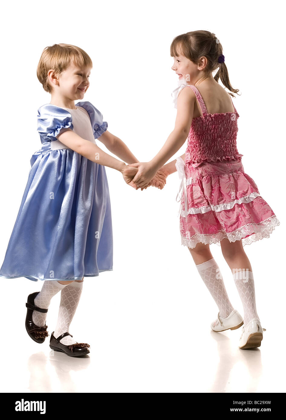 two little dancing girl in beautiful dresses isolated on white Stock ...