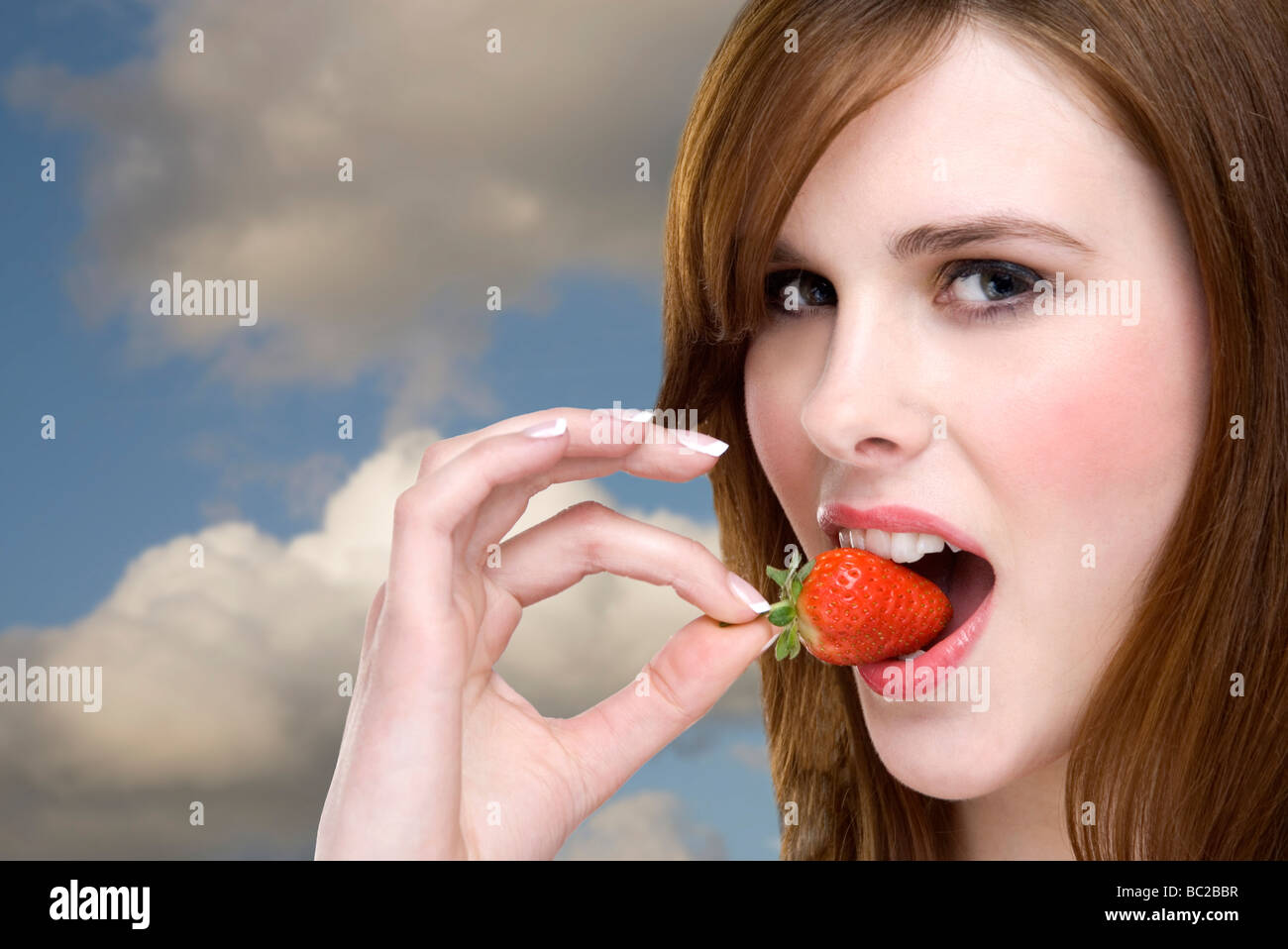 woman eating a strawberry fruit Stock Photo - Alamy