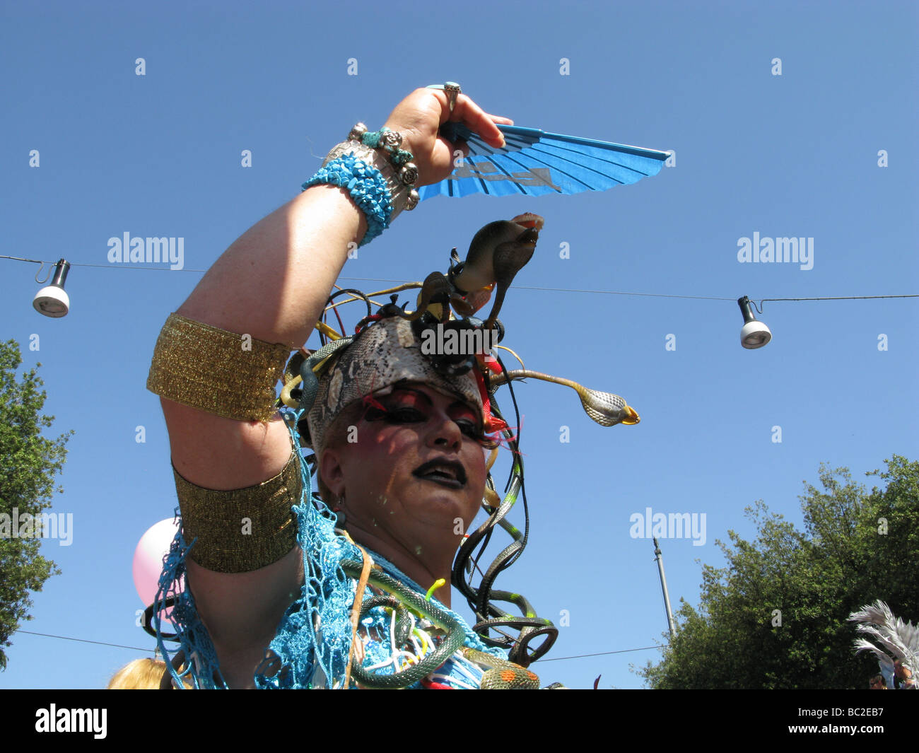 person with snakes fancy dress costume at gay pride rally, rome 2009 ...