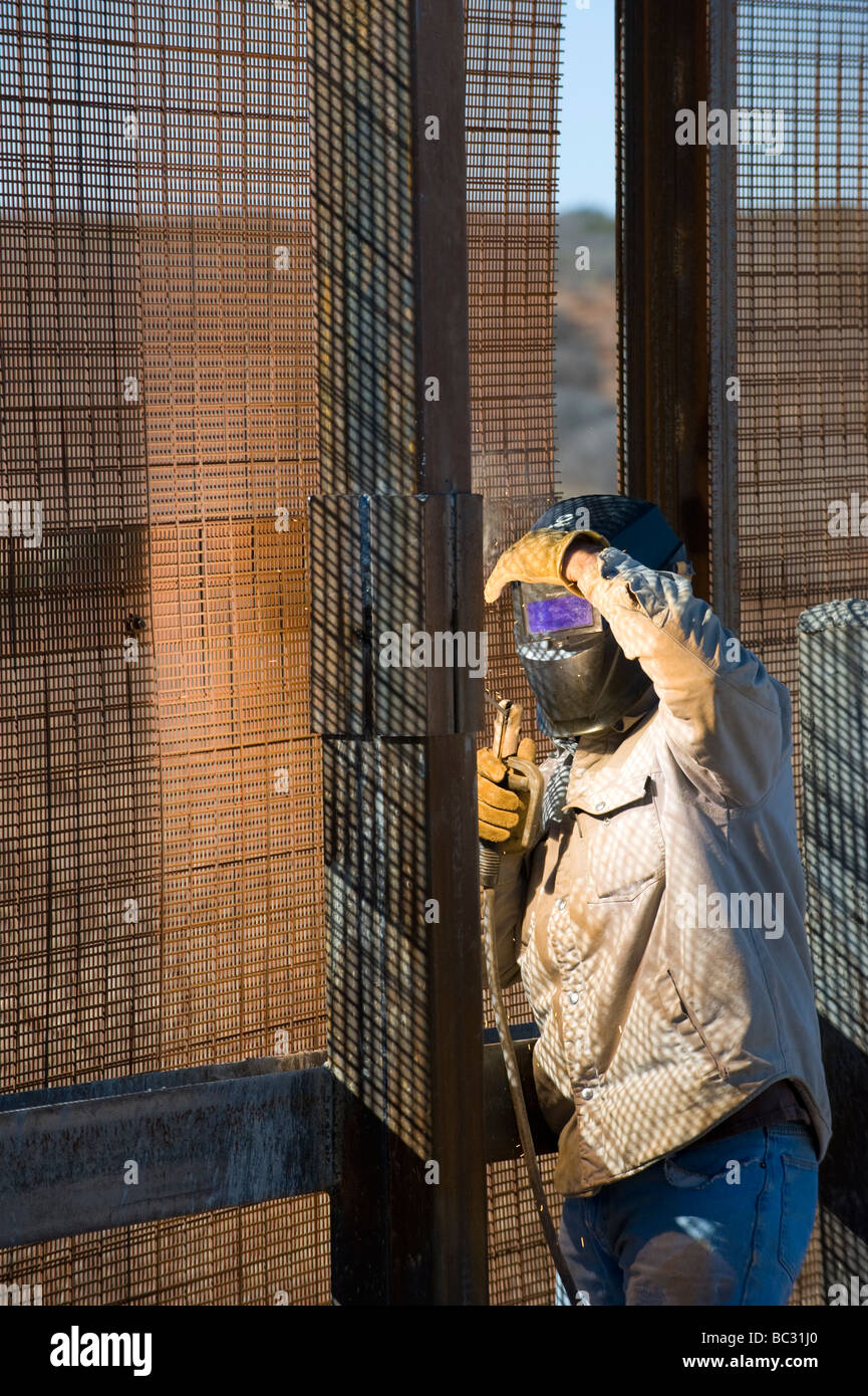 Welder repairs the pedestrian border fence with Mexico, AZ Stock Photo ...