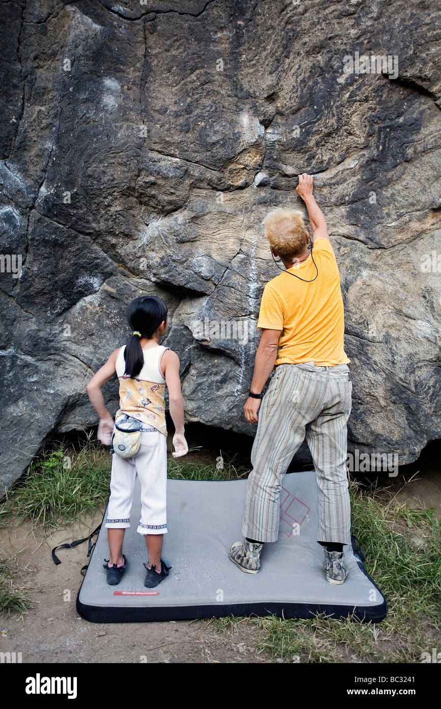 A young climber bouldering with her father in Central Park Stock Photo ...