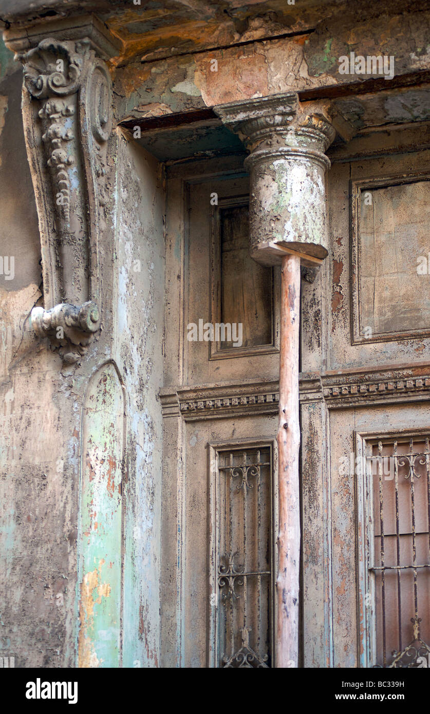 Support holding up the capitol of a collapsed column outside an old ...