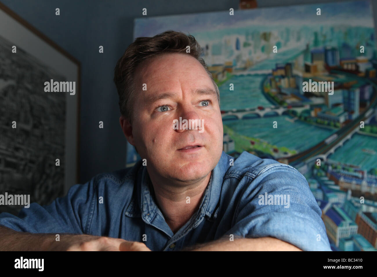 a portrait of a famous artist sitting in front of his most recent piece ...