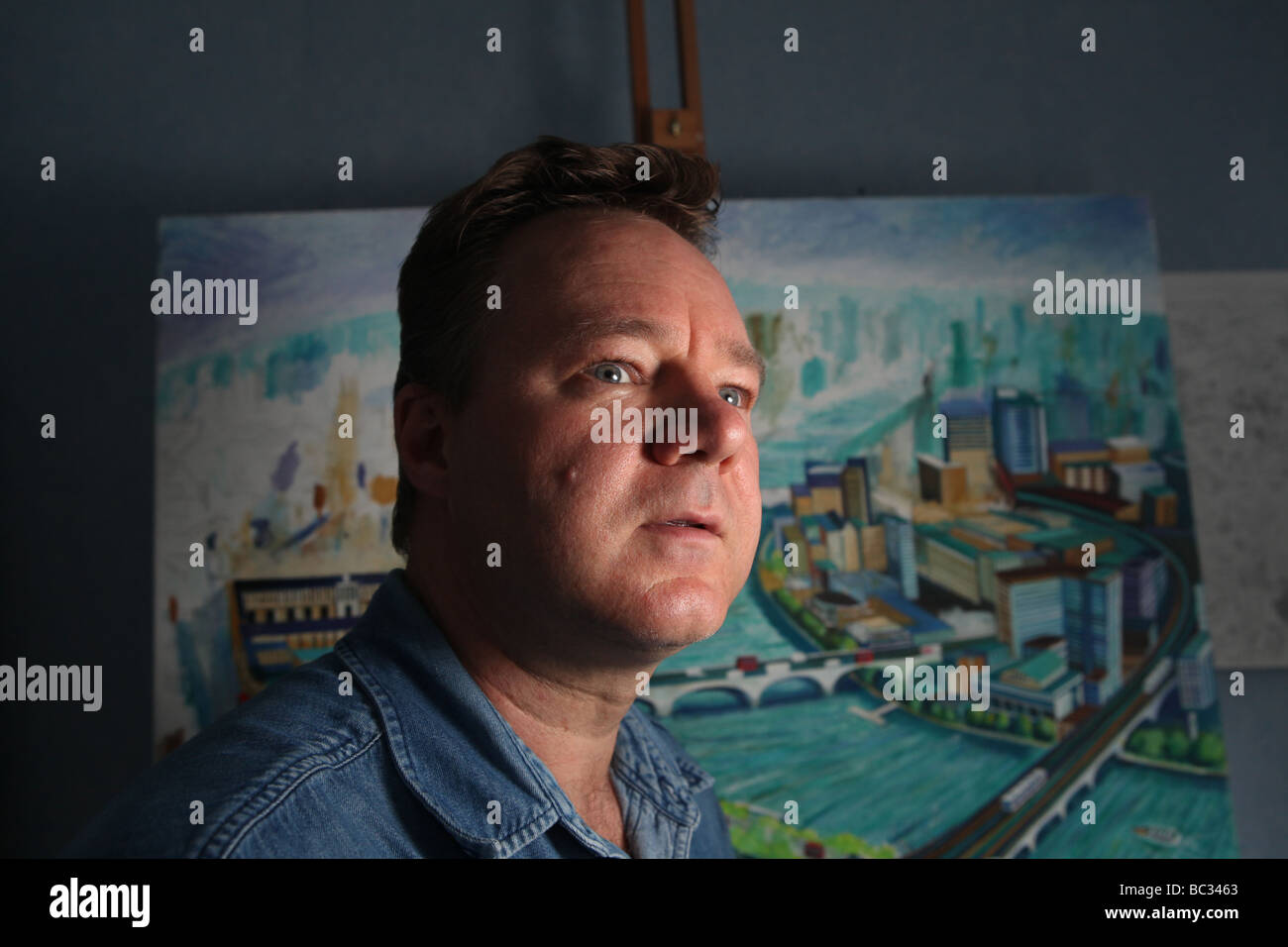 a portrait of a famous artist sitting in front of his most recent piece ...