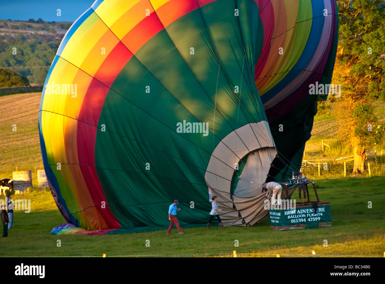hot air balloon landing in field Stock Photo - Alamy