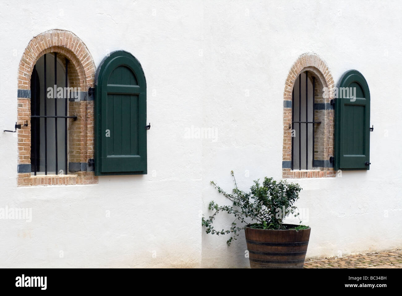 Arched windows with green wooden shutters of Cape Dutch homestead in ...