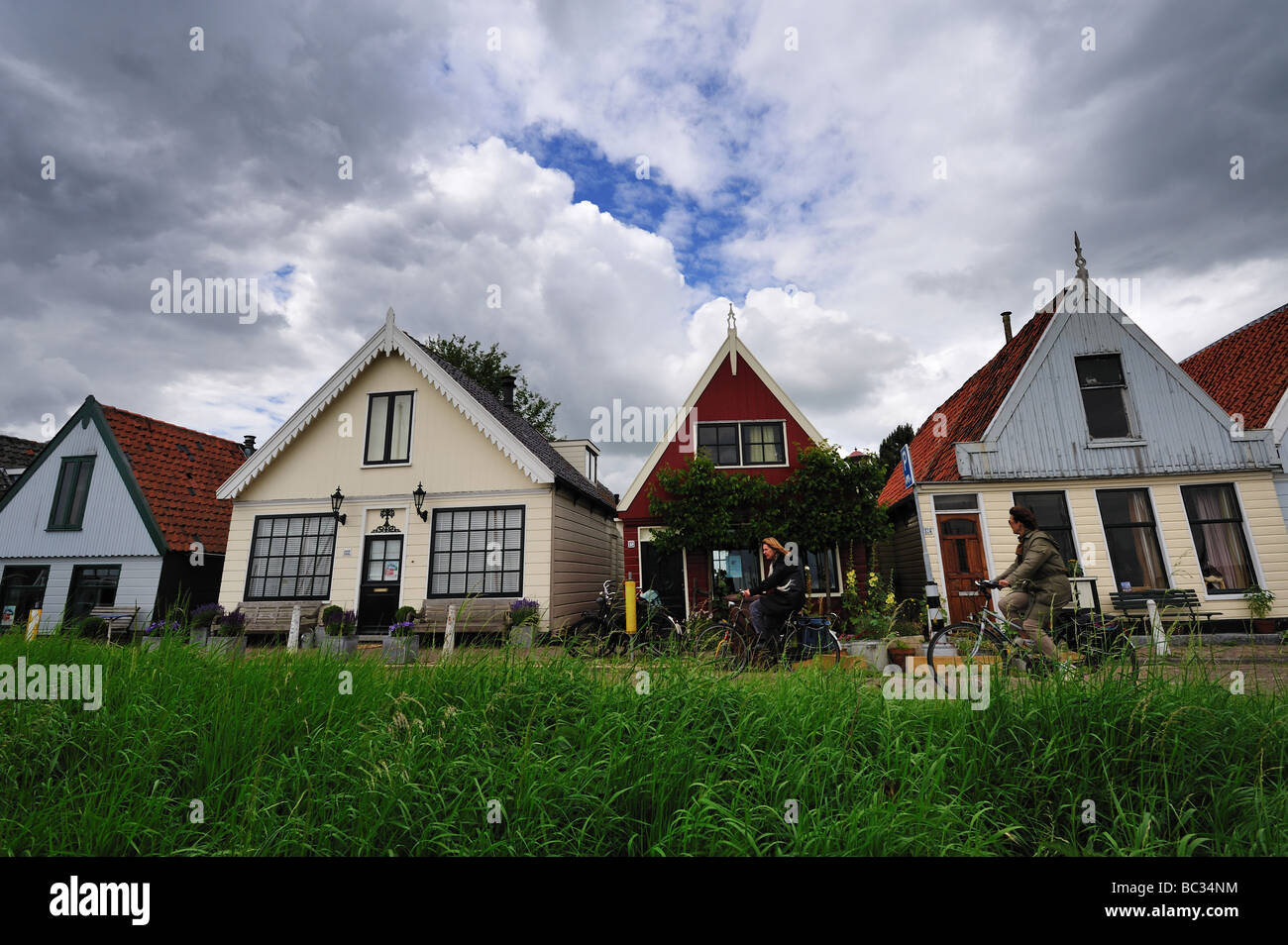 people cycling in a small Dutch village near Amsterdam in the ...