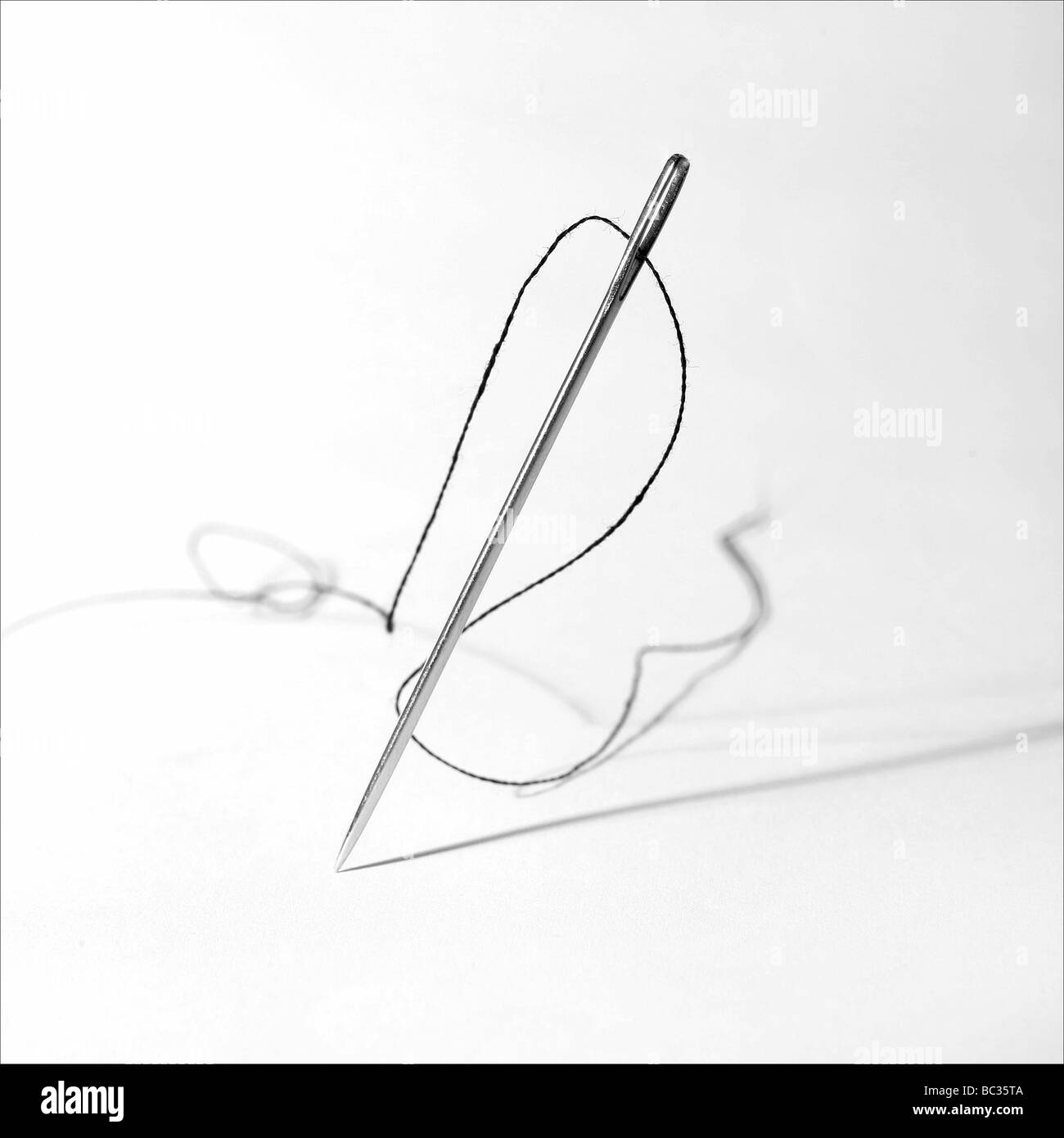 Sewing thread and needle Stock Photo - Alamy