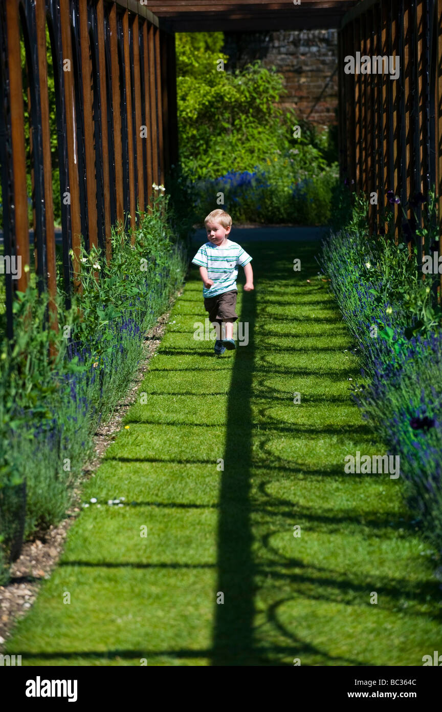 Little boy running in the garden Stock Photo - Alamy