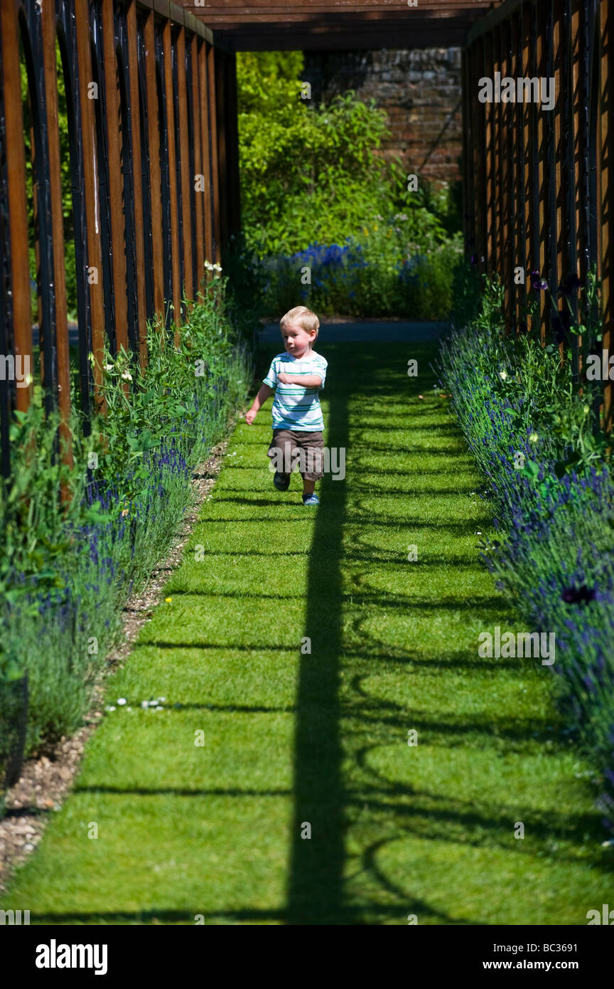 Little boy running in the garden Stock Photo - Alamy