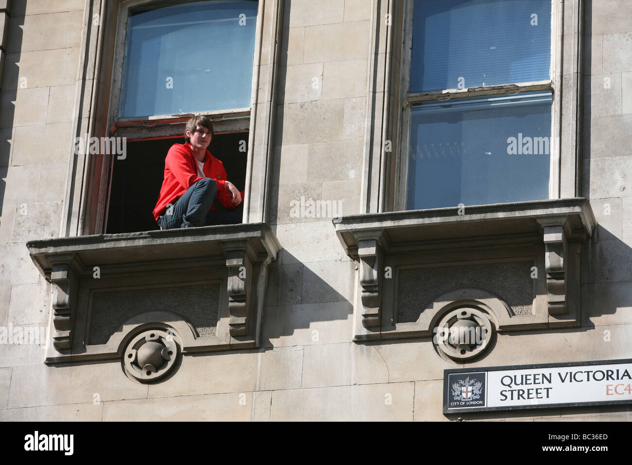 onlookers in a building in london city center looking out of a window ...