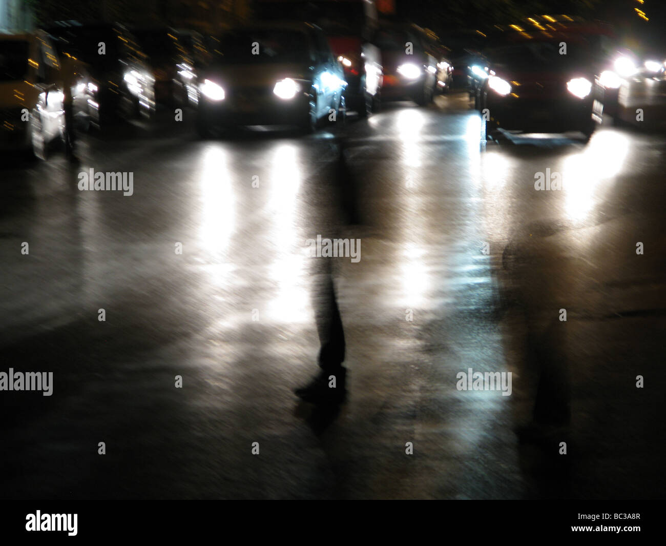 pedestrians and cars in dark street at night Stock Photo - Alamy
