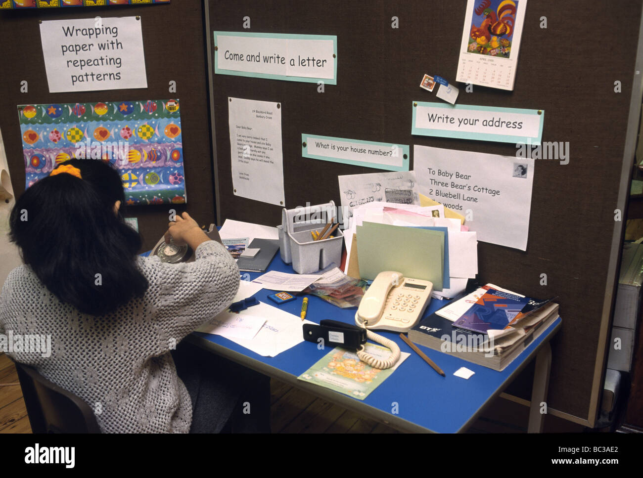 primary school child playing at a math activity corner in classroom ...
