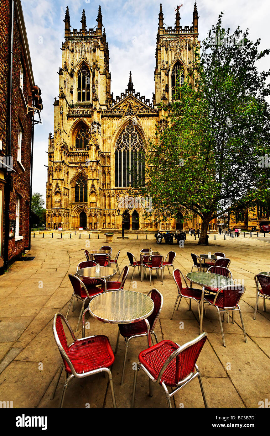 Tables and chairs outside a cafe on High Petergate York, York Minster ...
