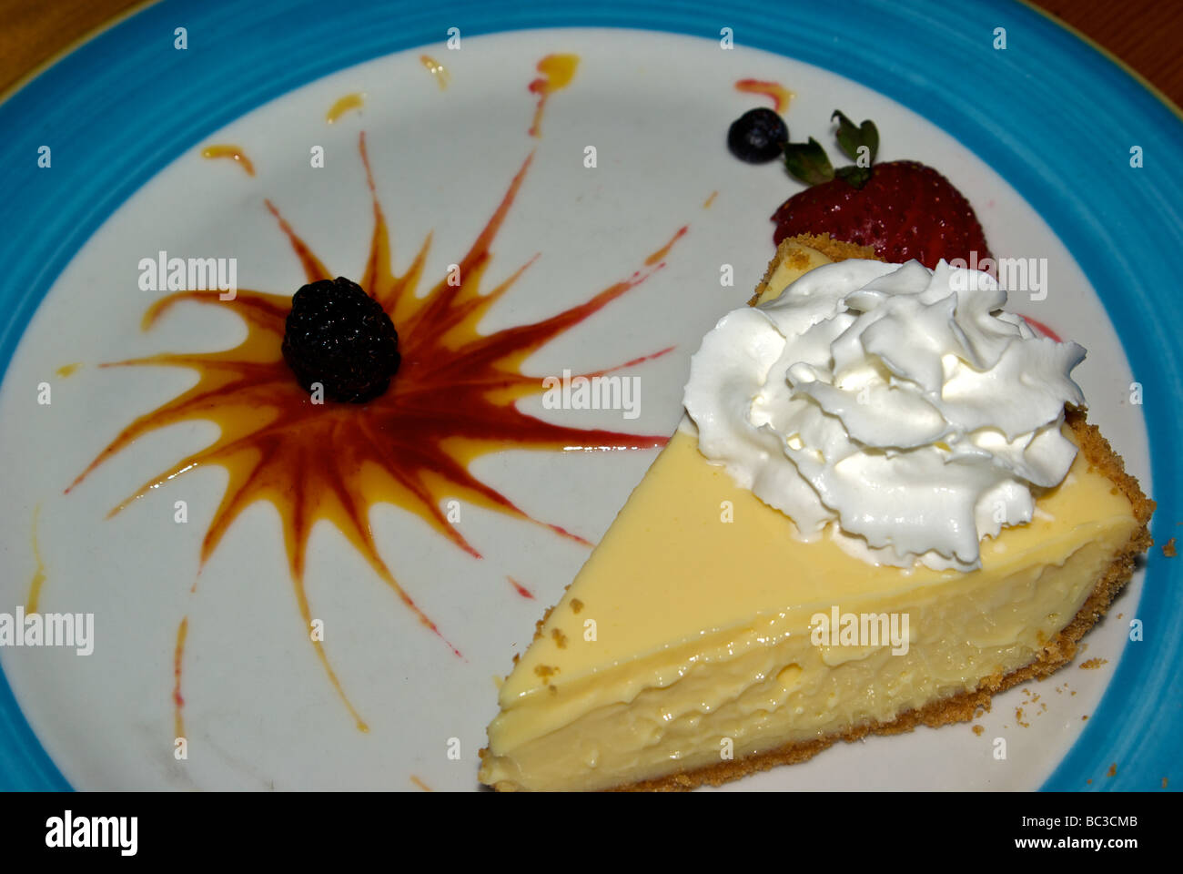 Key lime pie with strawberry blackberry blueberry whipped cream garnish ...