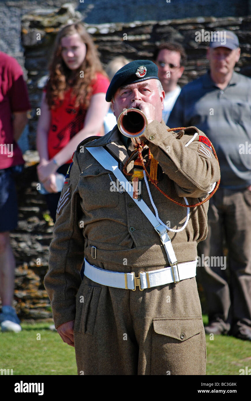 a world war two british soldier playing the trumpet at a military event ...