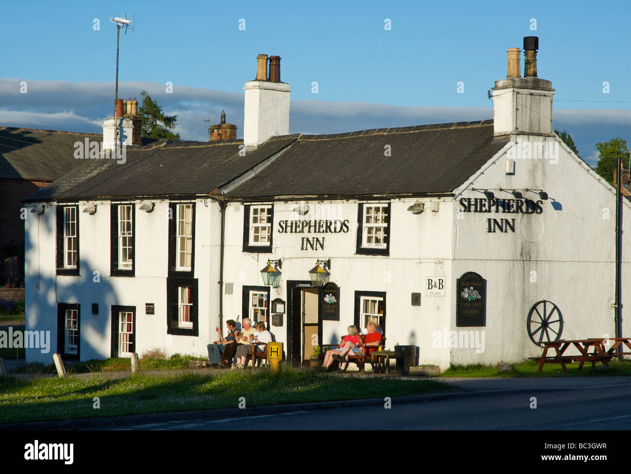 People sitting outside the Shepherds Inn, in the village Langwathby ...