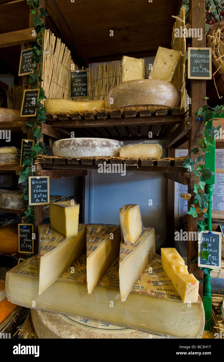 Selection of handmade cheeses on display in the artisan fromagerie ...