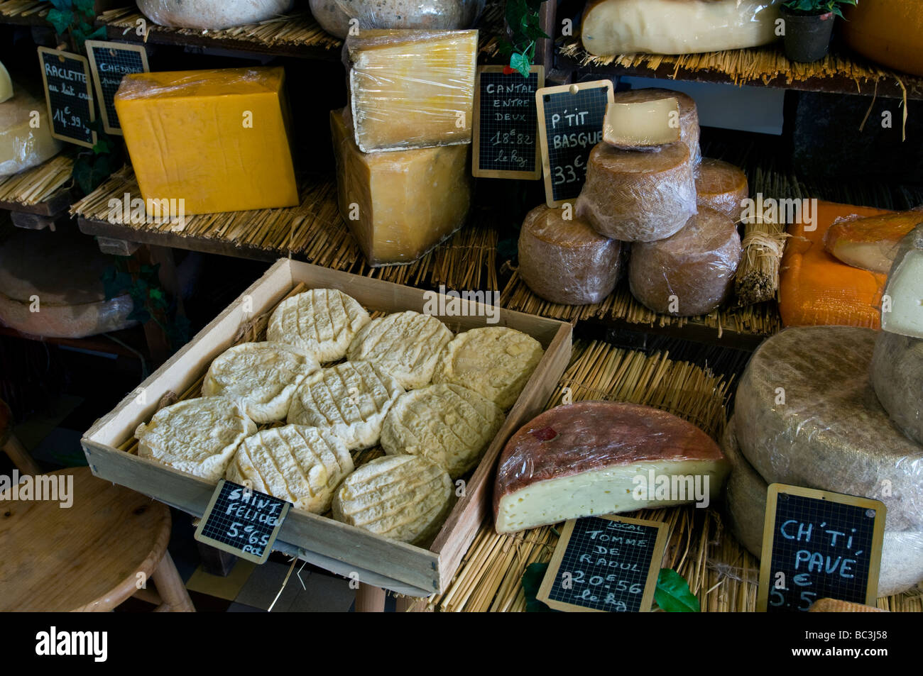Selection of handmade cheeses on display in the artisan fromagerie ...