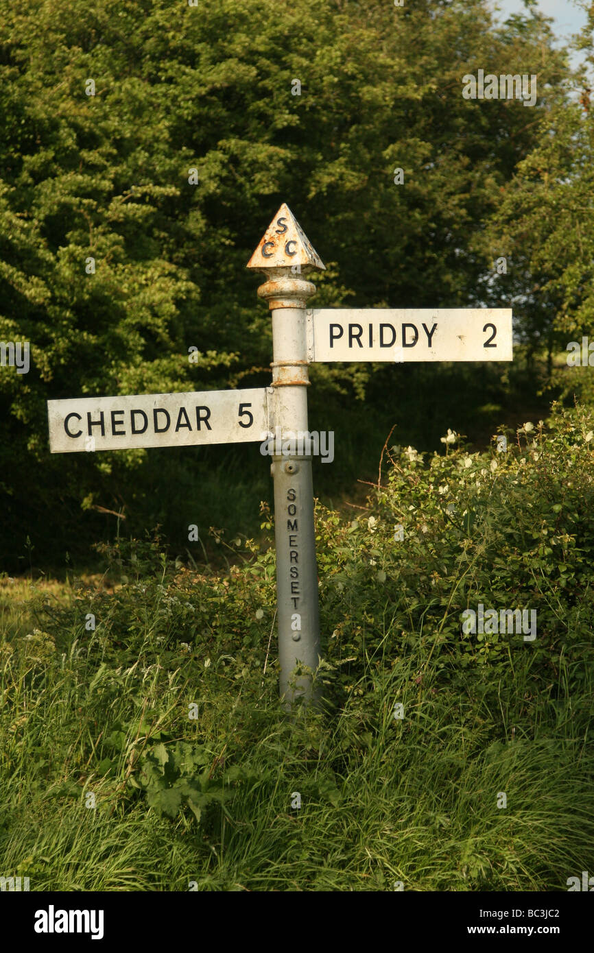 Road sign 5 miles to Cheddar, 2 to Priddy Stock Photo - Alamy