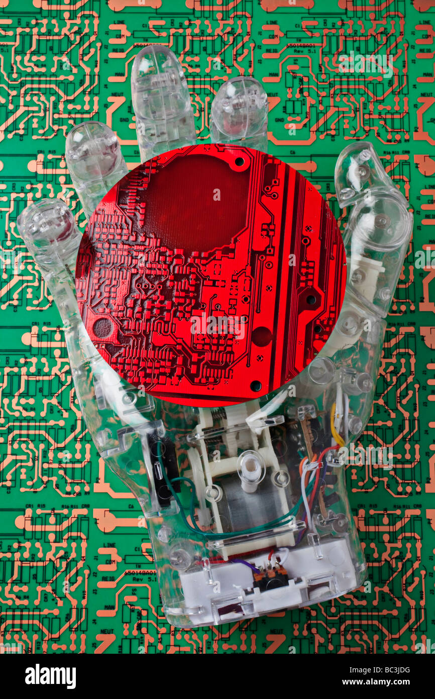 Clear robot hand holding round circuit board Stock Photo - Alamy