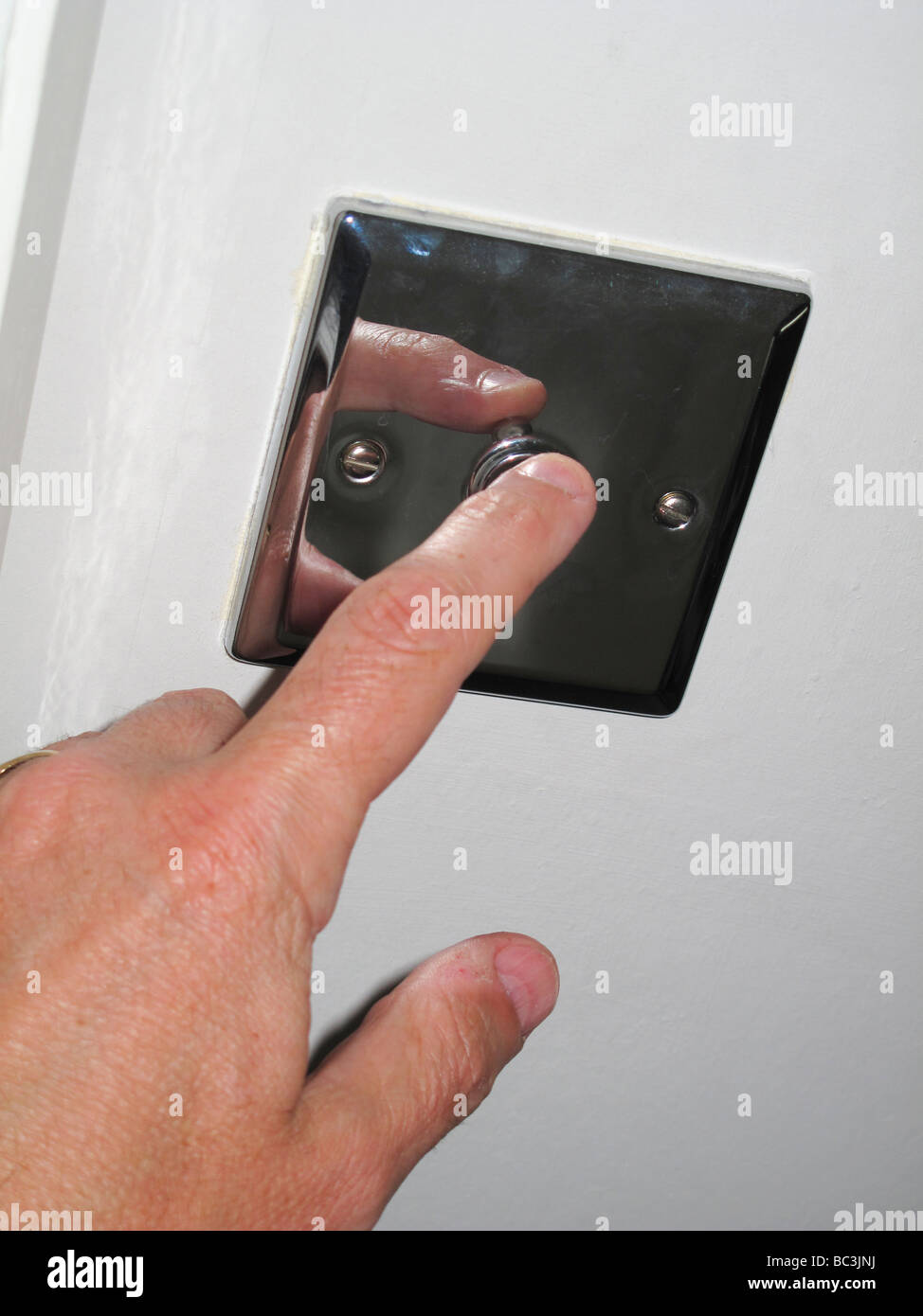 Hand at light switch hi-res stock photography and images - Alamy