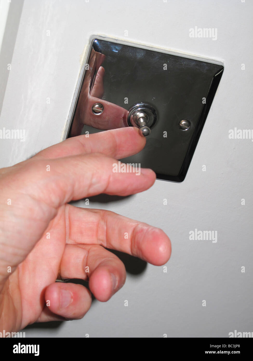 Male hand switching light switch Stock Photo - Alamy