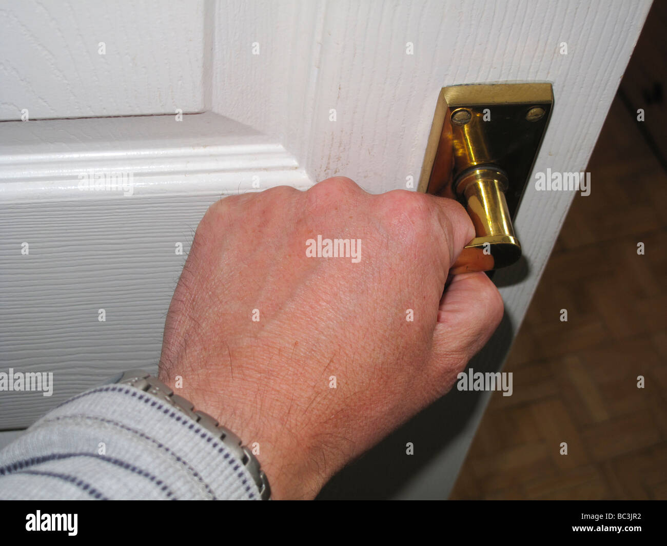 Male hand operating door handle Stock Photo - Alamy