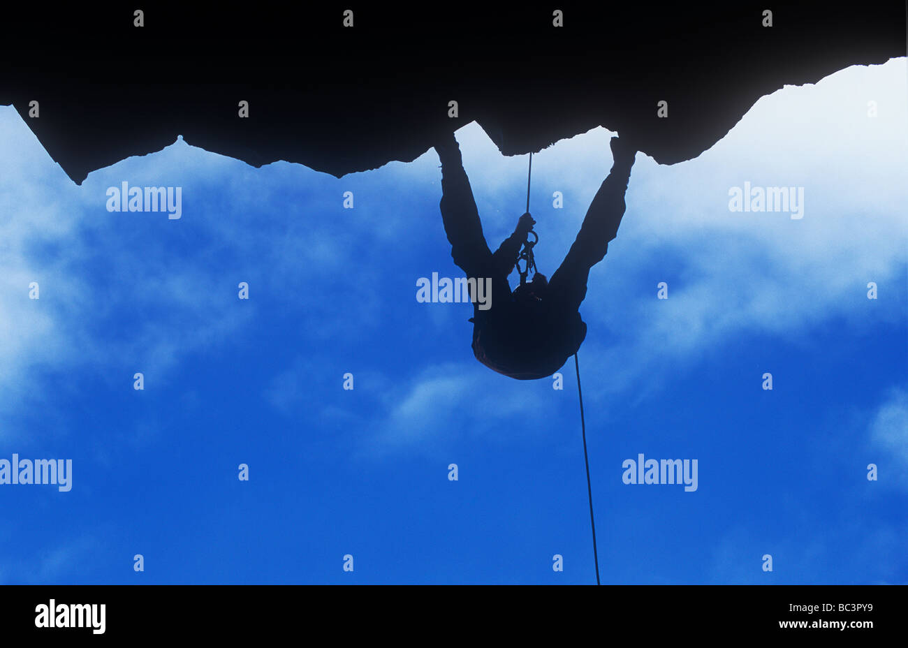 A man abseiling down a cliff in the Lake District UK Stock Photo - Alamy