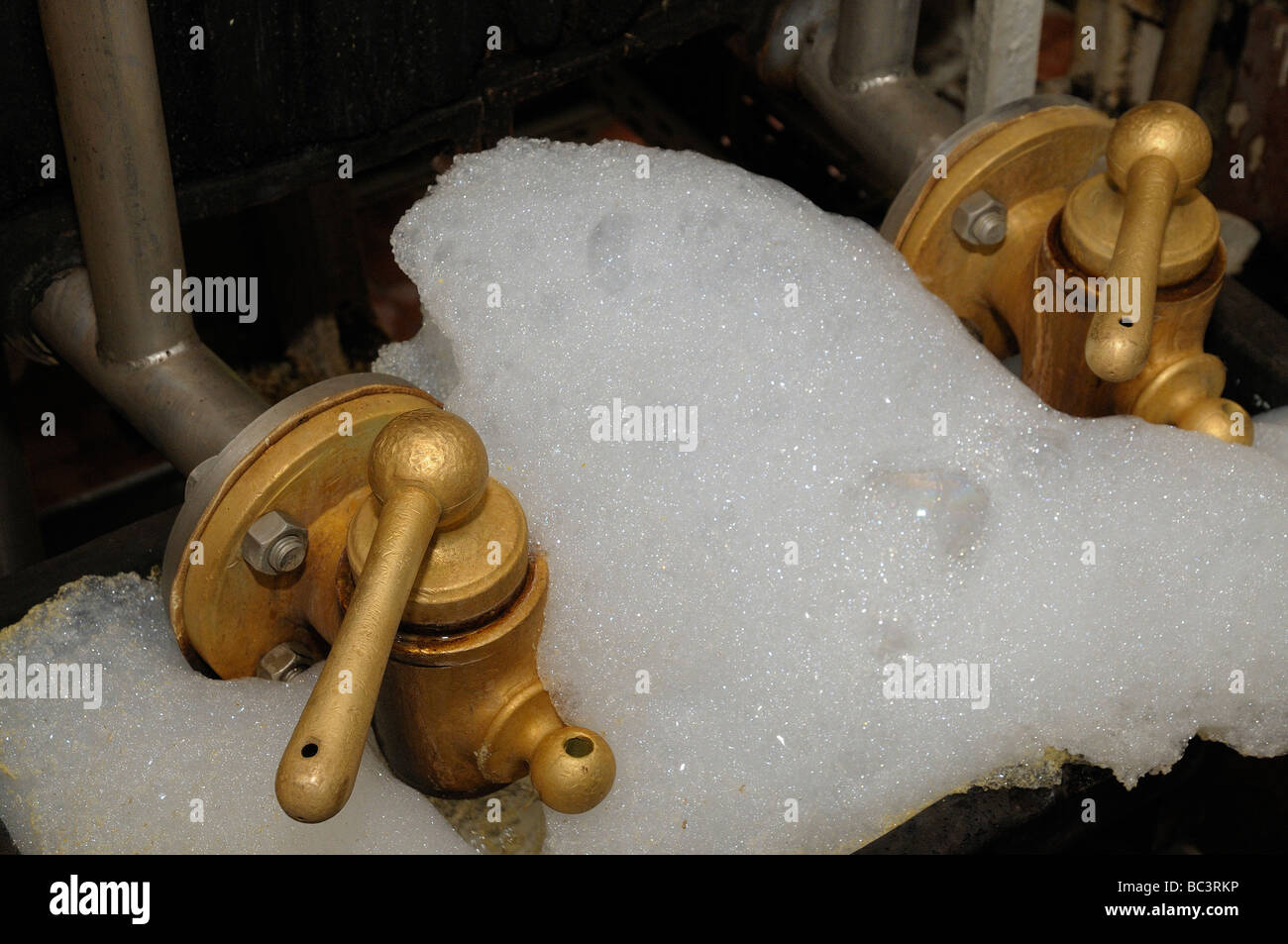 Foam spills out the bottom of a mash tun at the St Feuillien brewerym ...