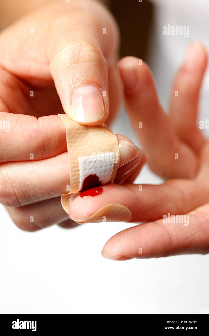 Plaster applyed to a little wound on a finger Stock Photo - Alamy