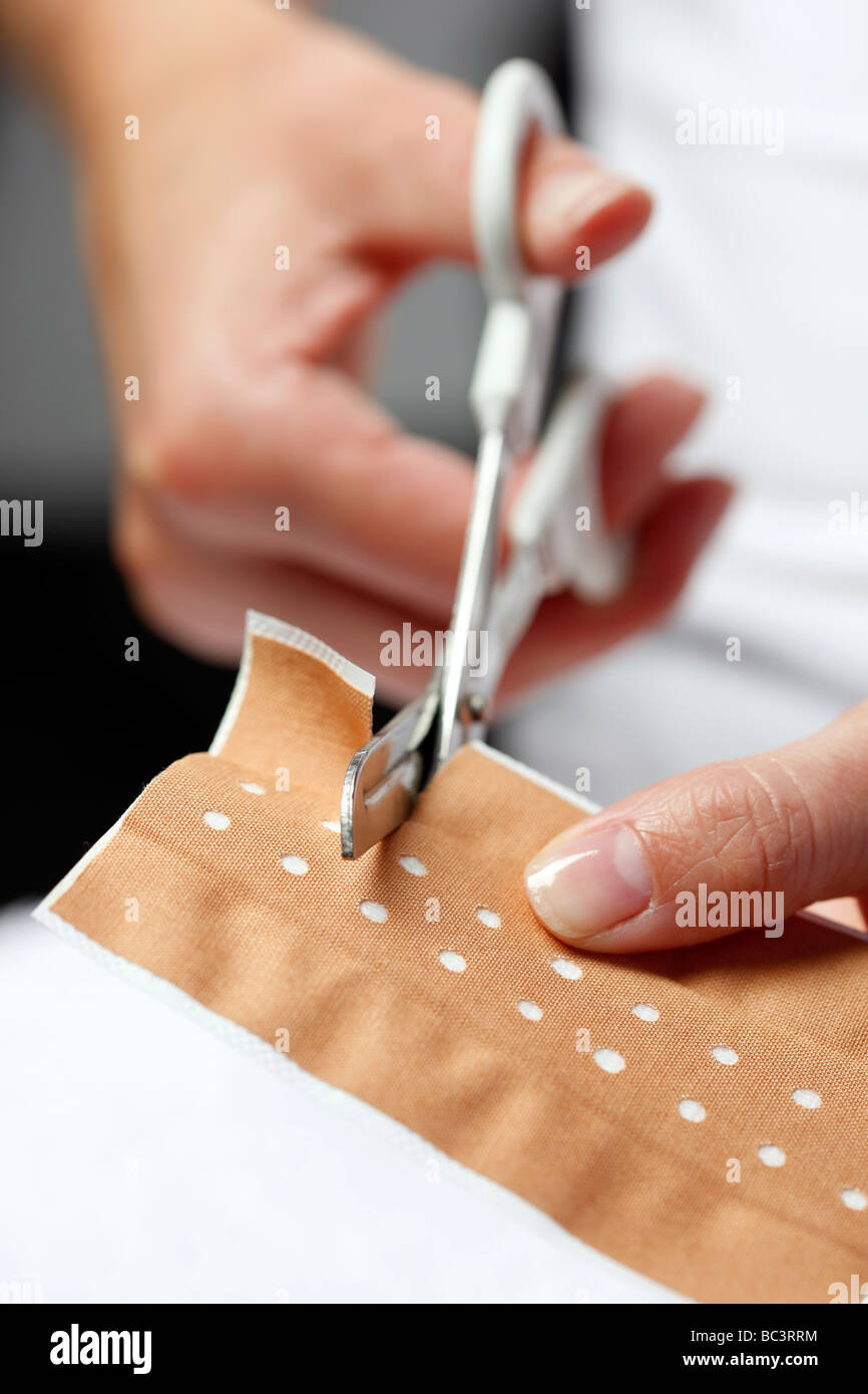 Plaster cutting to apply the plaster to a little wound Stock Photo - Alamy