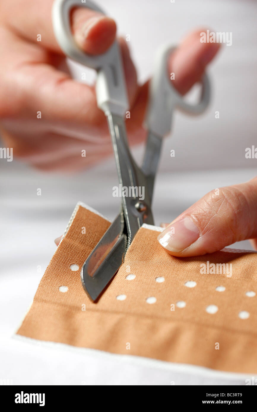 Plaster cutting to apply the plaster to a little wound Stock Photo - Alamy