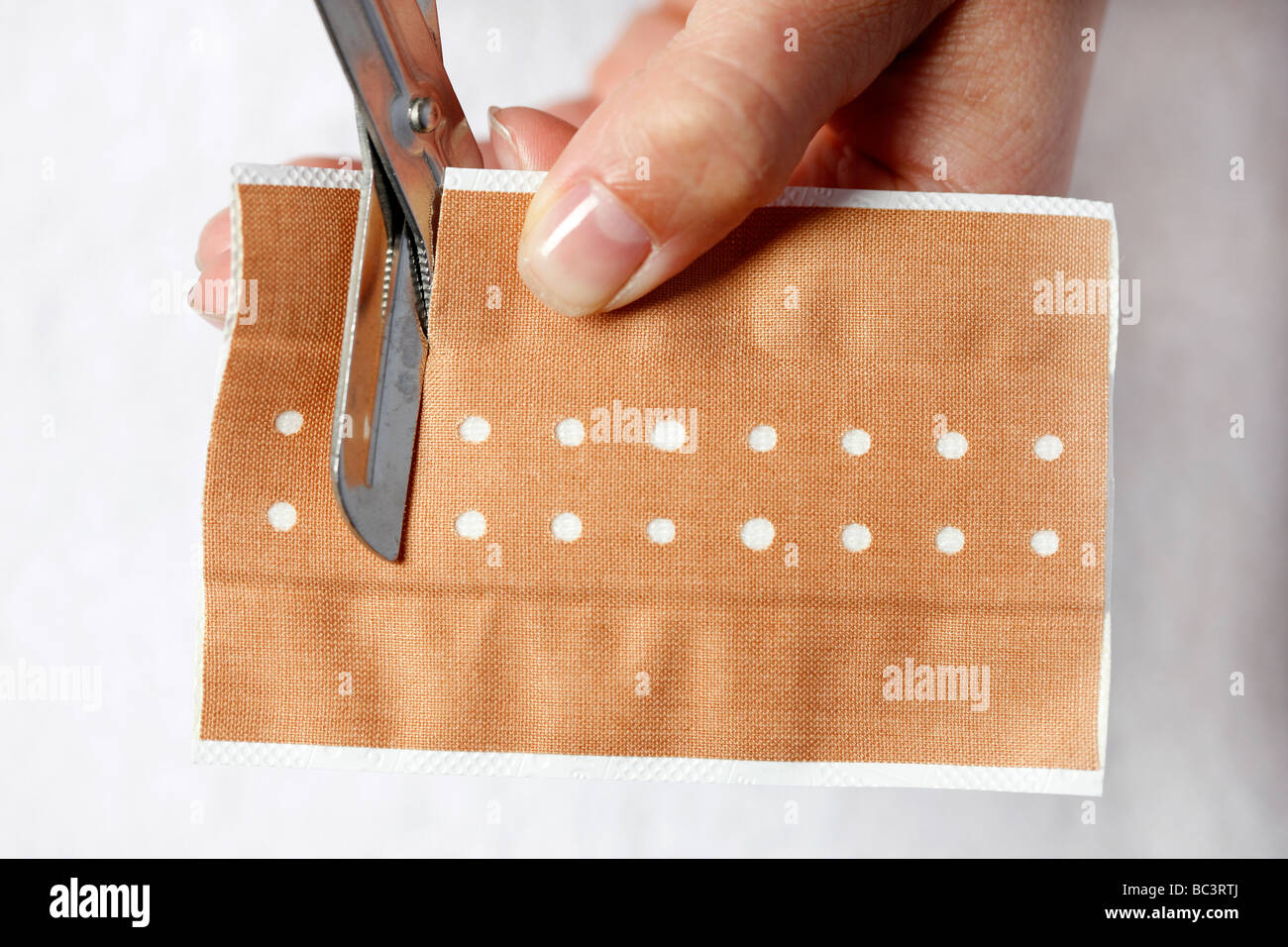 Plaster cutting to apply the plaster to a little wound Stock Photo - Alamy