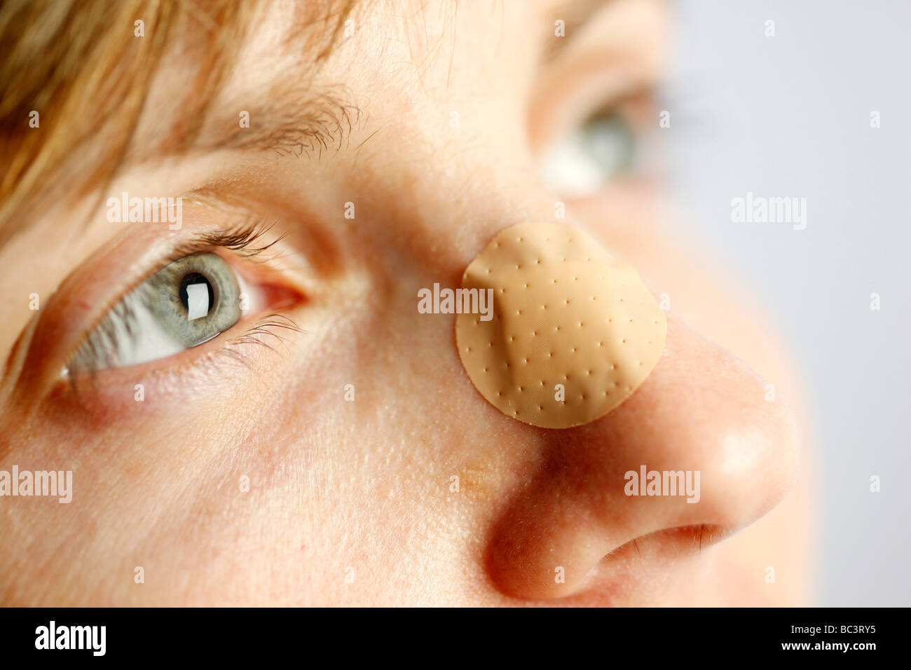 Woman has a plaster on her face Stock Photo - Alamy
