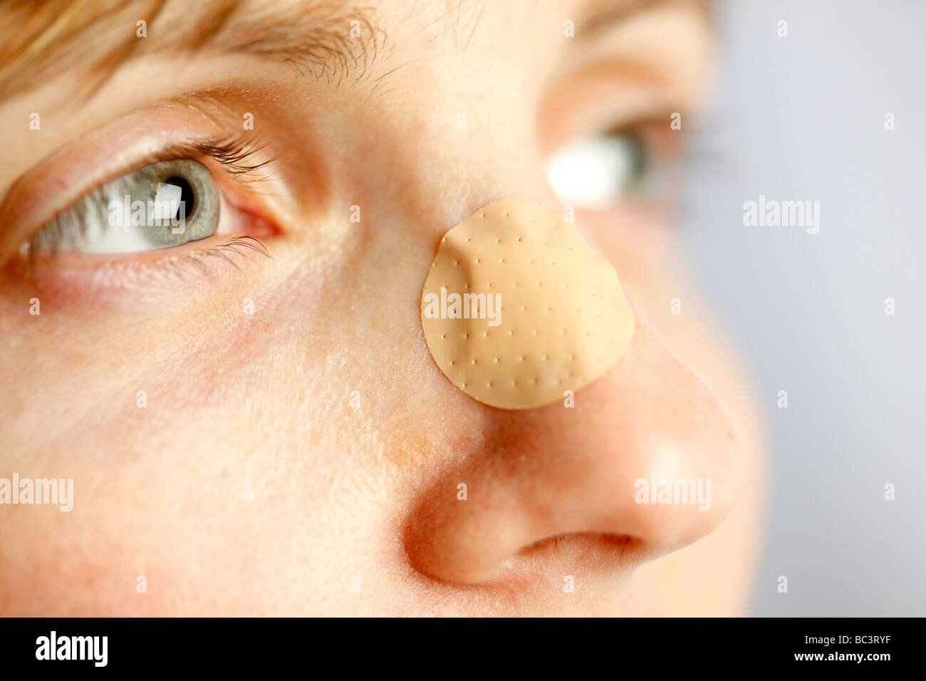 Woman has a plaster on her face Stock Photo - Alamy