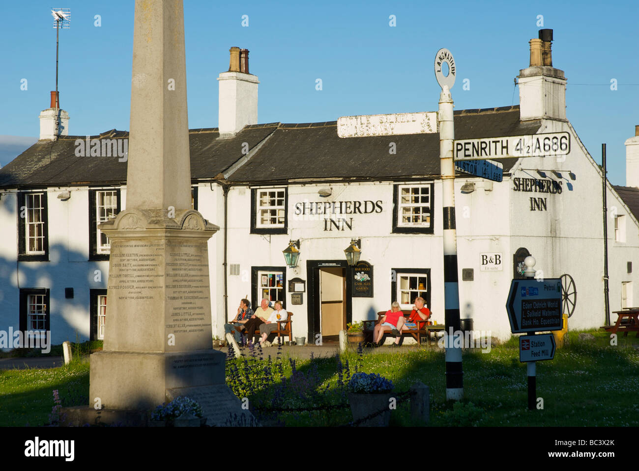 People sitting outside the Shepherds Inn, in the village Langwathby ...