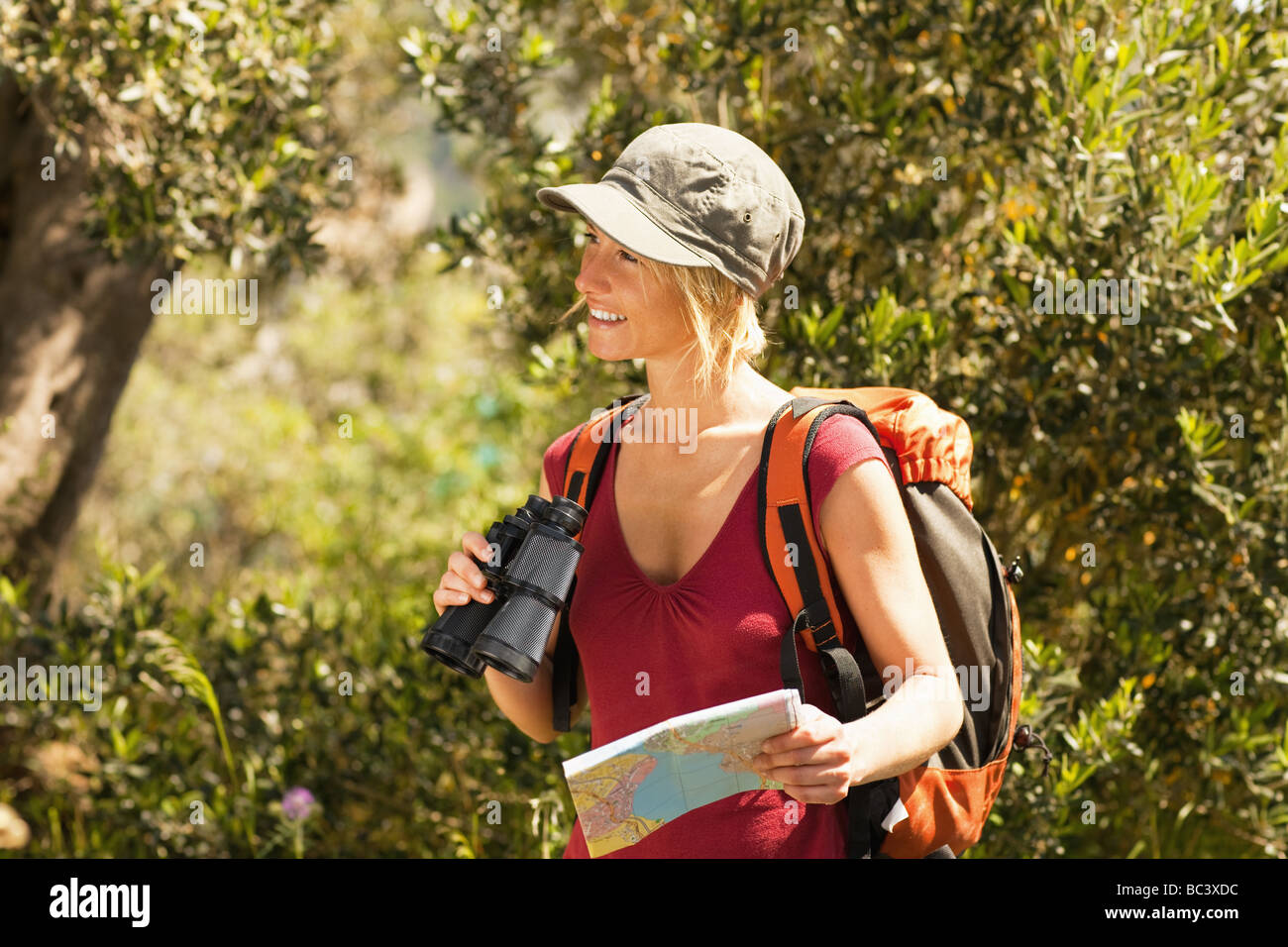 female bird watcher holding binoculars and map Stock Photo - Alamy