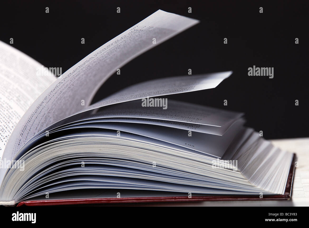 Open book on dark background Stock Photo - Alamy