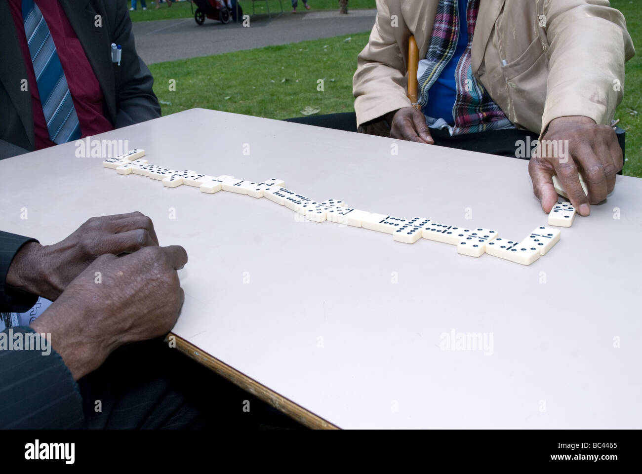 Men playing dominoes in the park Stock Photo - Alamy