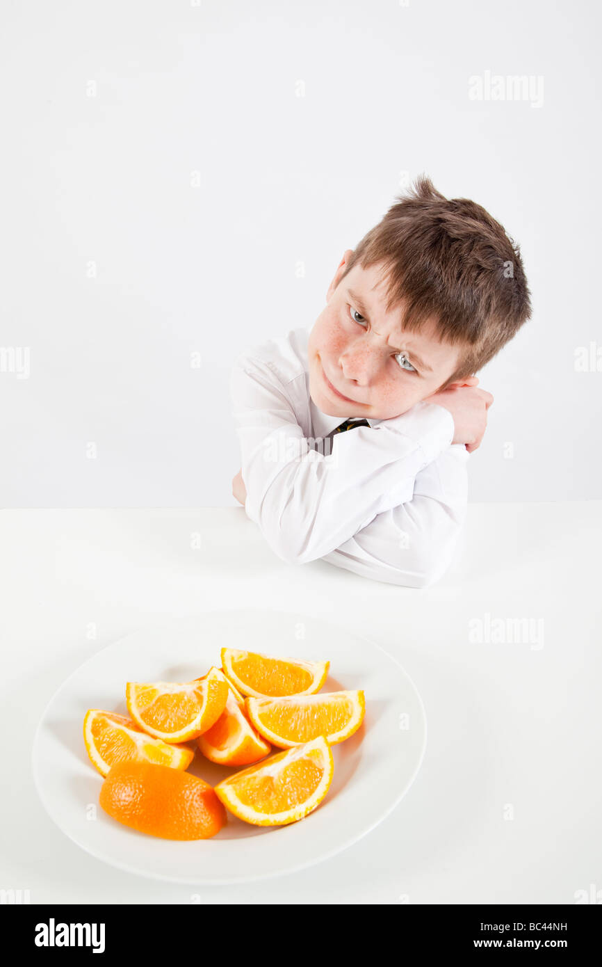 School boy eating oranges Stock Photo - Alamy