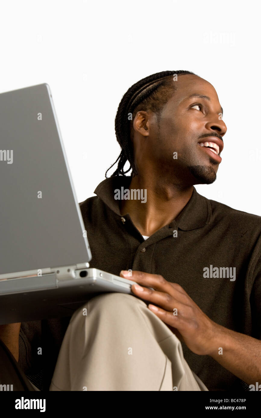 Man using laptop computer looking off camera Stock Photo - Alamy