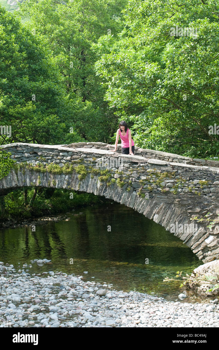 Women on traditional stone bridge in the Lake District Stock Photo - Alamy