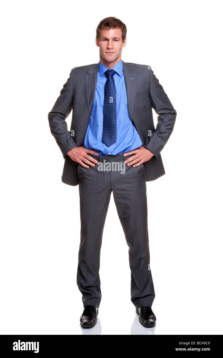 Businessman in a pinstripe suit standing with his hands on his hips ...
