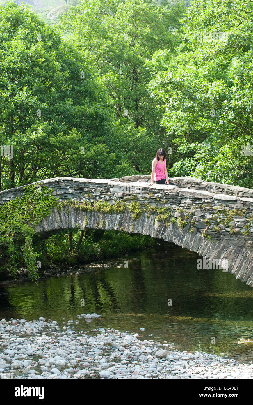 Women on traditional stone bridge in the Lake District Stock Photo - Alamy
