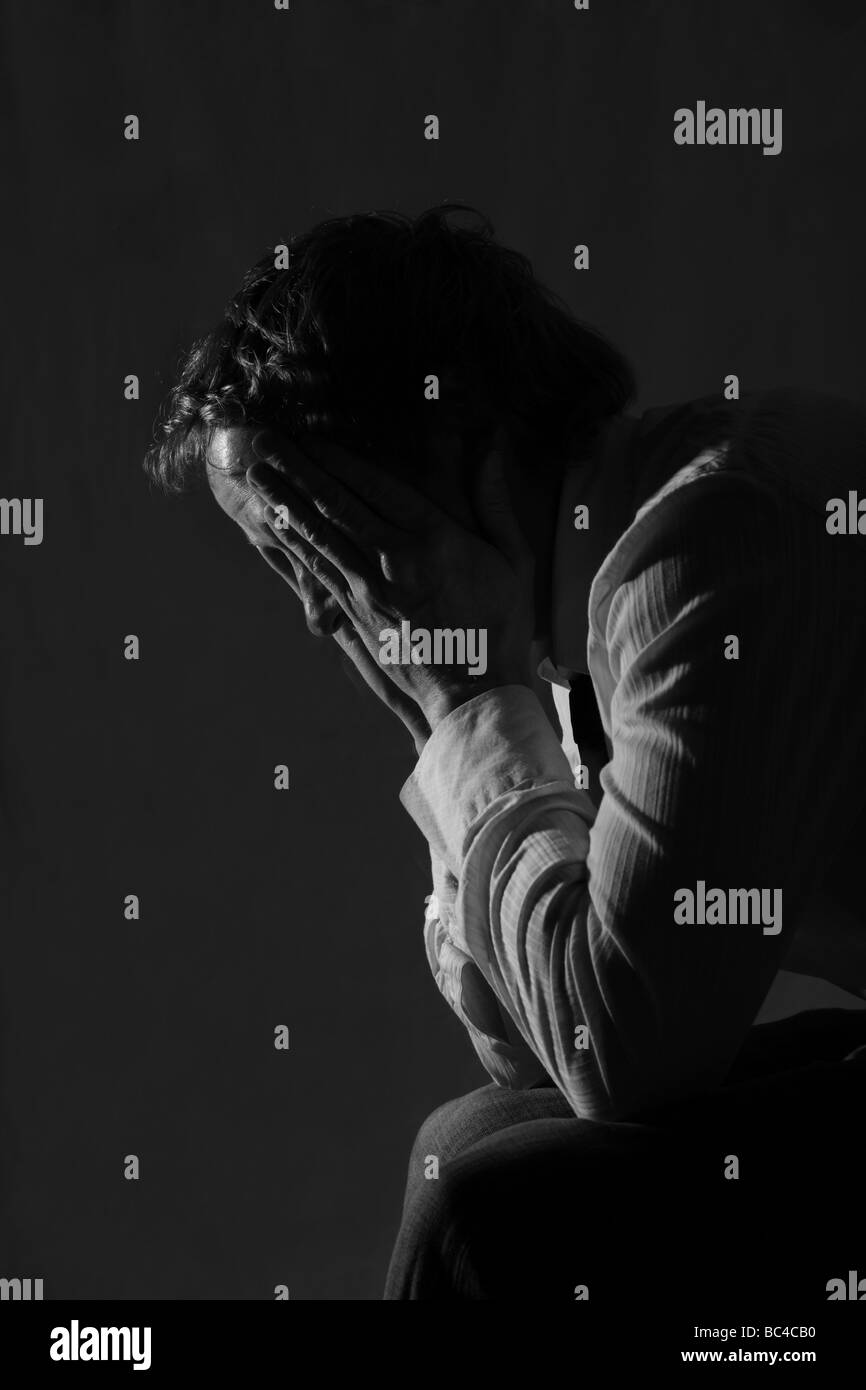 A man with his head in his hands Stock Photo - Alamy