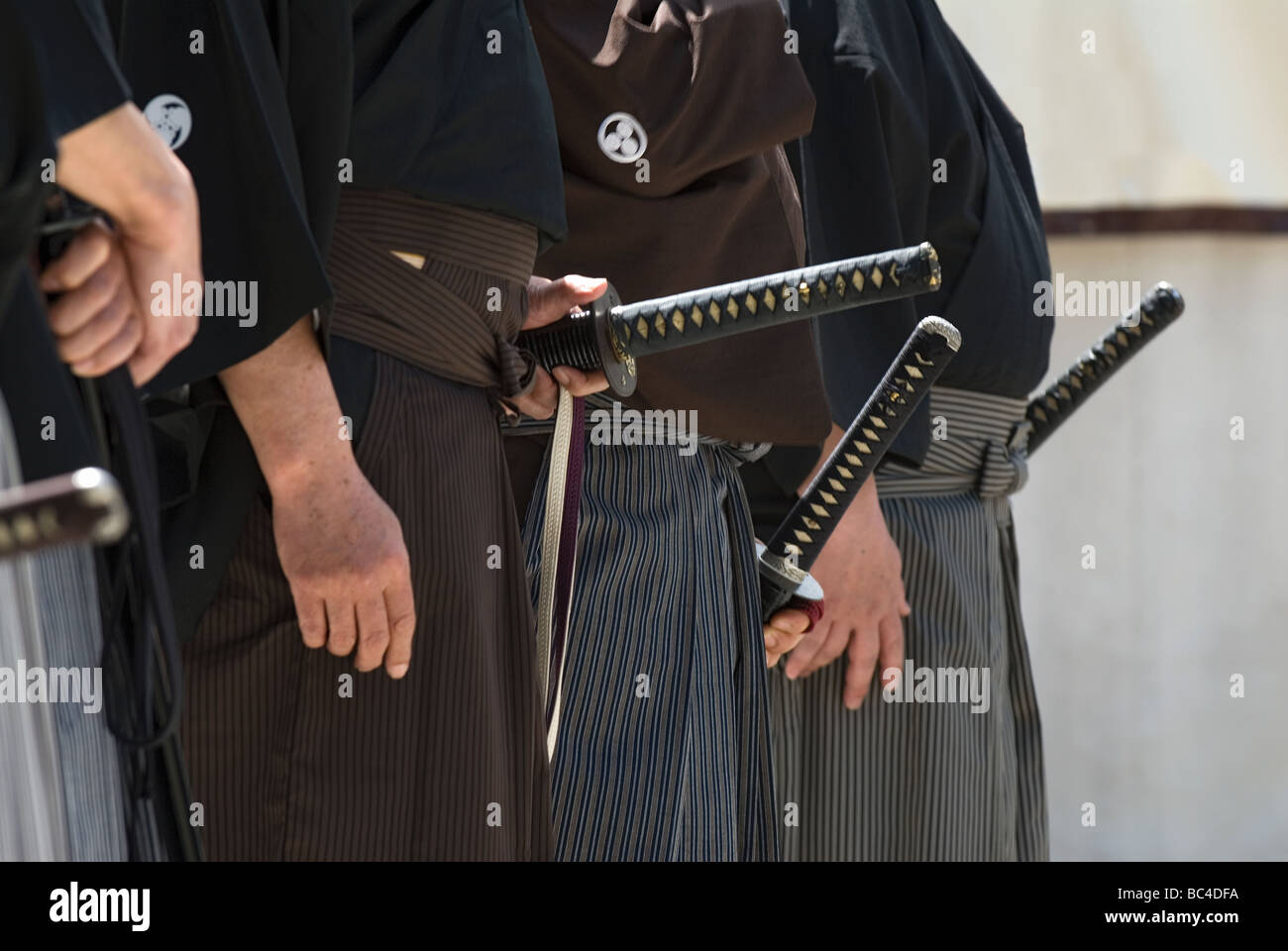 A close up shot of two men holding real Japanese samurai swords or ...