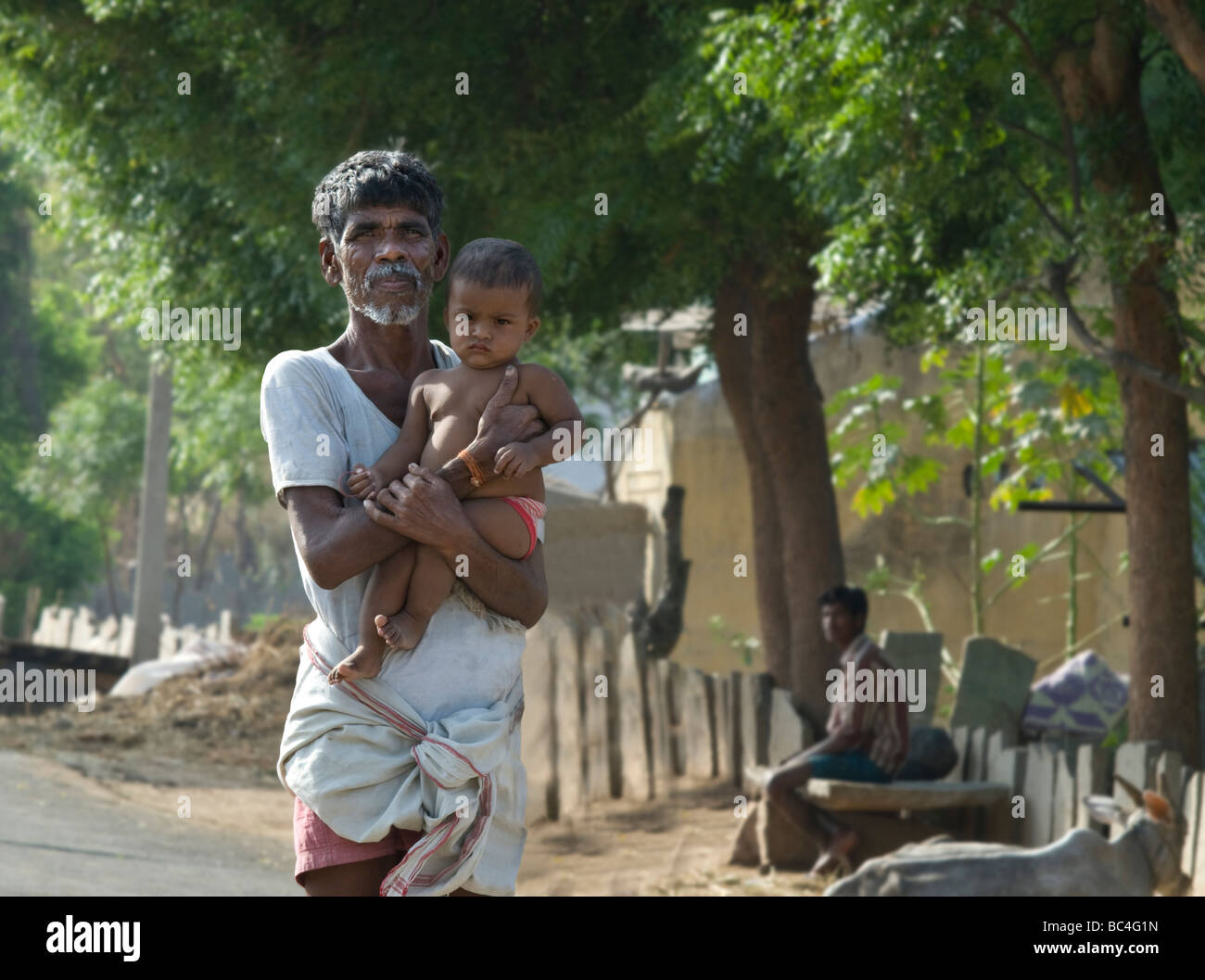 old father holds his son in a small village in the early morning Stock ...